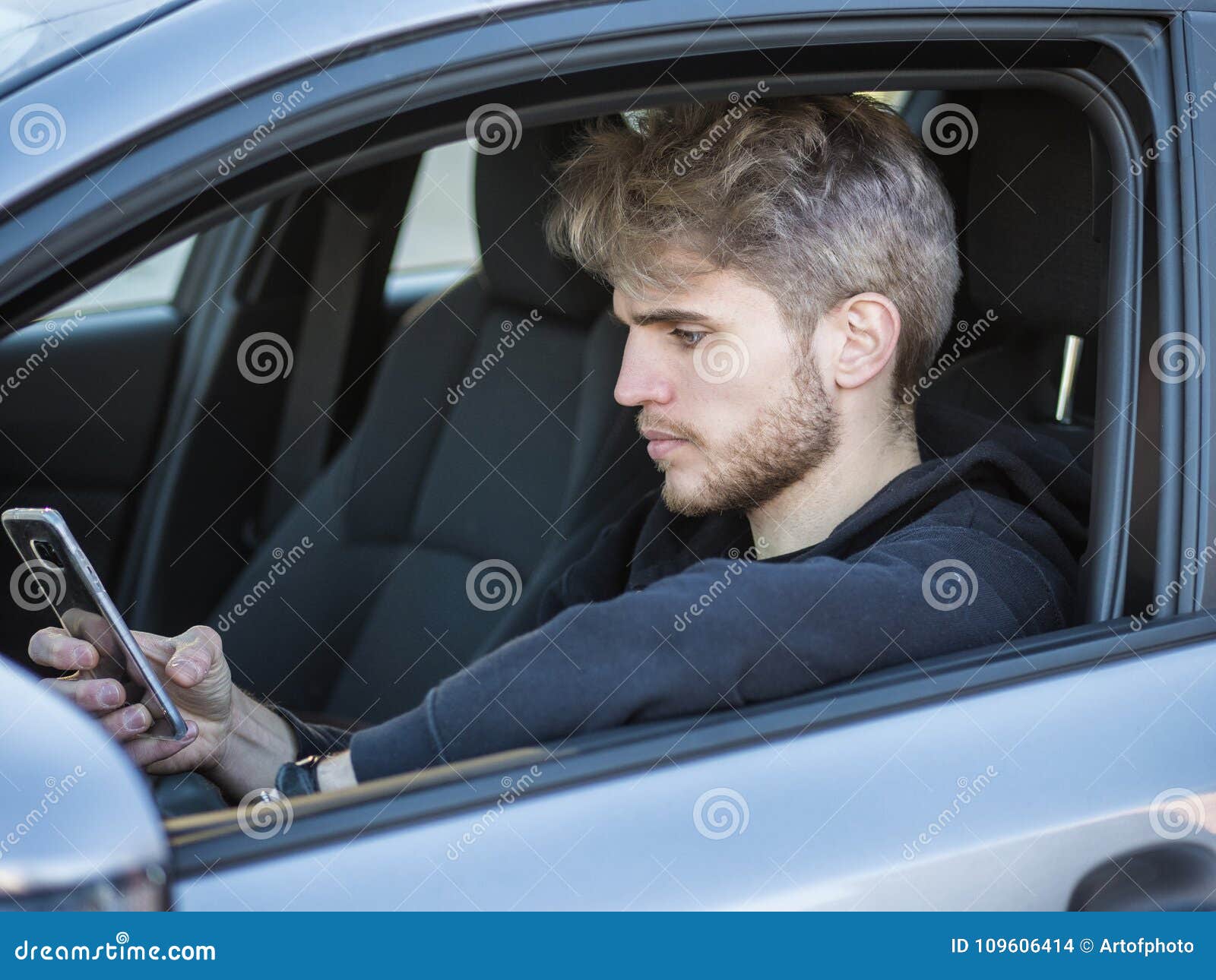 Young Man Using Mobile Phone while Driving Stock Photo - Image of view ...