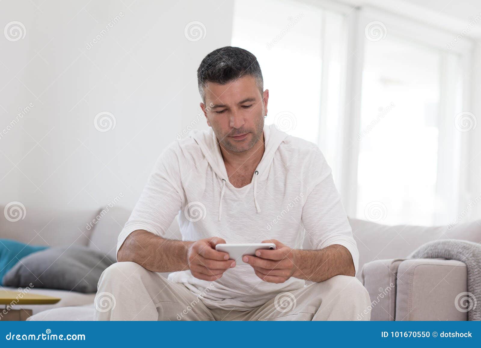 Young Man Using a Mobile Phone at Home Stock Photo - Image of portrait ...