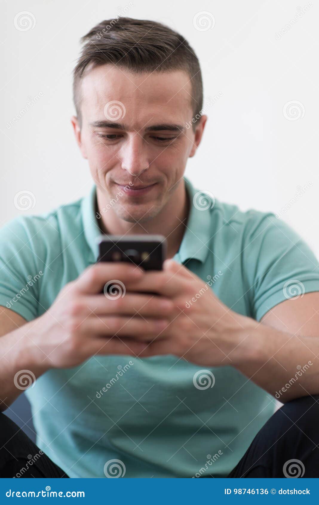 Young Man Using a Mobile Phone at Home Stock Photo - Image of relax ...