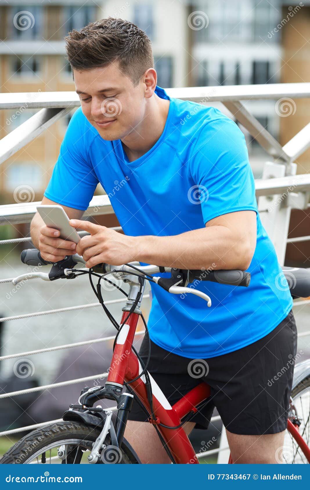 Young Man Using Mobile Phone Whilst Out on Cycle Ride Stock Image ...