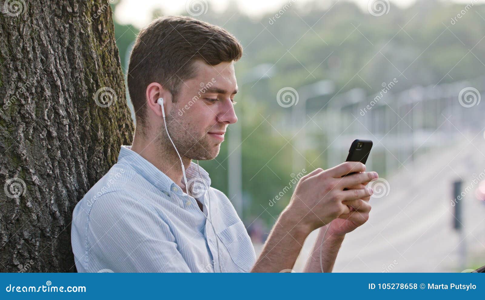 A Young Man Using a Mobile Outdoors Stock Photo - Image of road, male ...