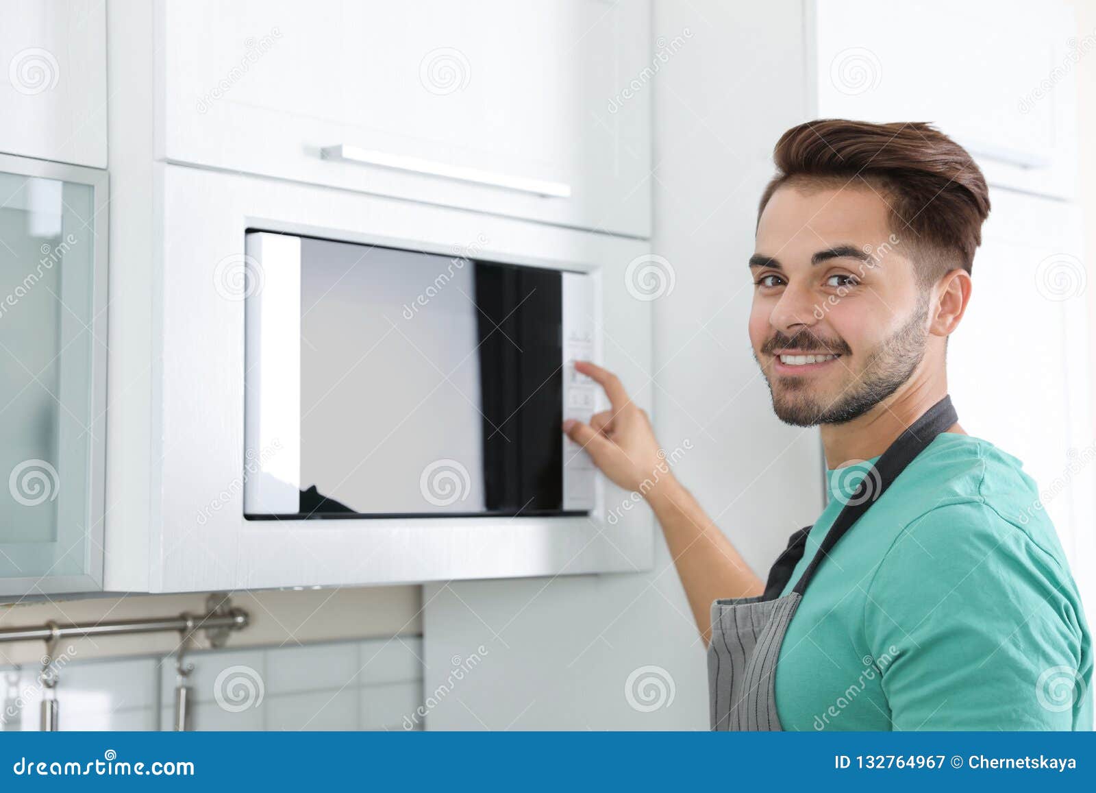 Young Man Using Modern Microwave Oven Stock Image - Image of happy ...
