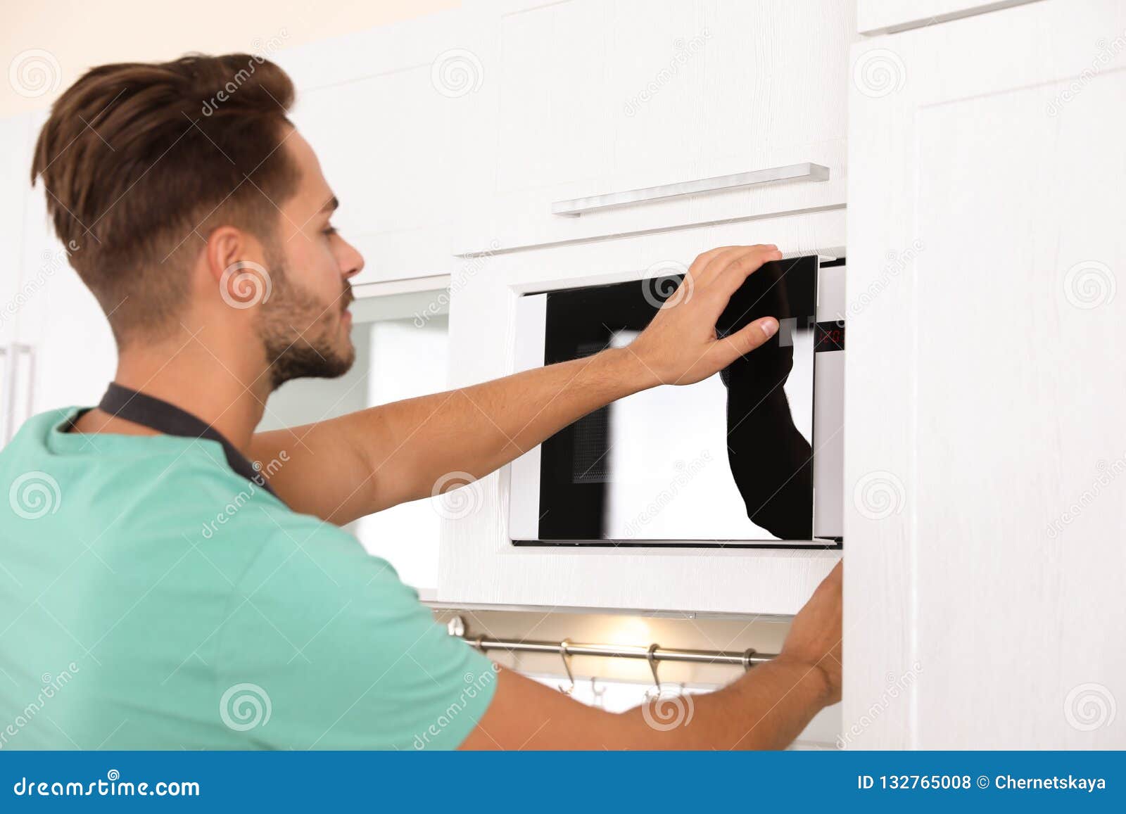 Young Man Using Modern Microwave Oven Stock Photo - Image of oven ...