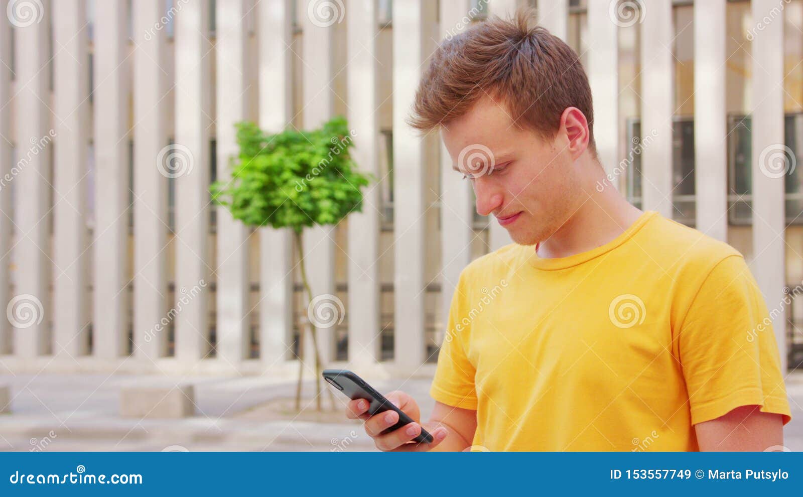 Man Using a Phone Outdoors stock image. Image of fashion - 153557749