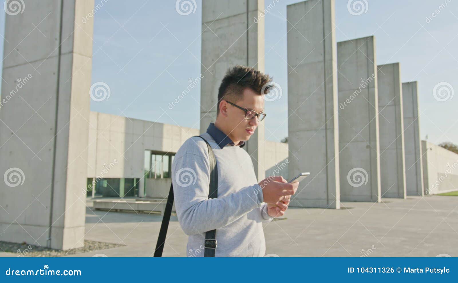 A Young Man Using a Phone Outside Stock Photo - Image of technology ...