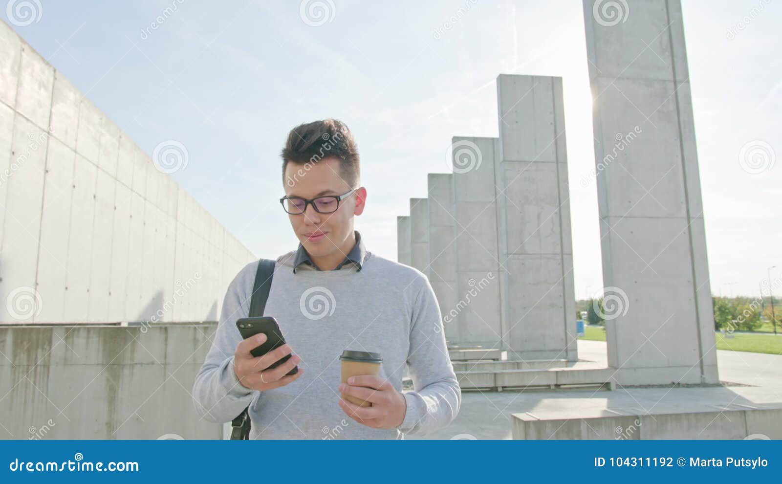A Young Man Using a Phone Outside Stock Photo - Image of slab ...