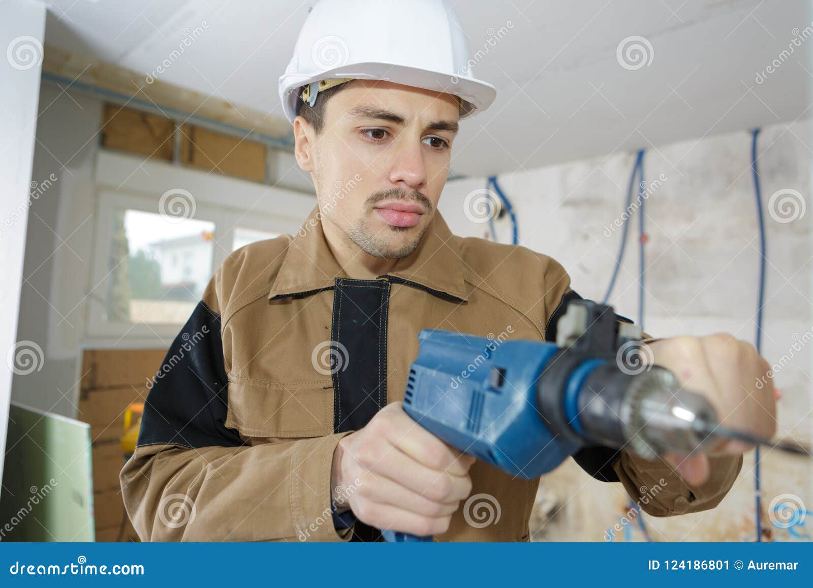 Young Man Using Power Drill on Wall at Home Stock Image - Image of tool ...