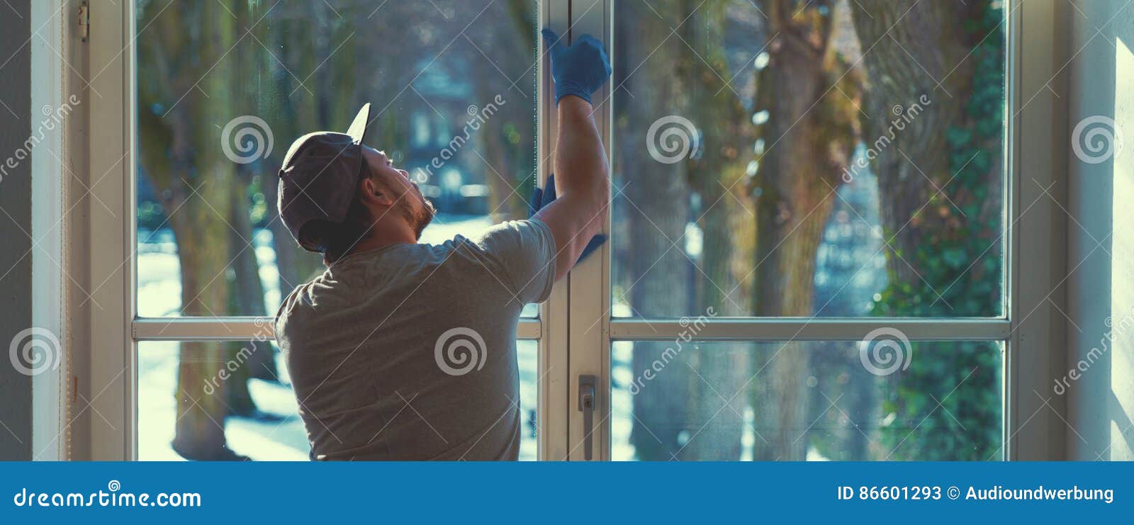 Young Man is Using a Rag and Squeegee while Cleaning Windows. Stock ...