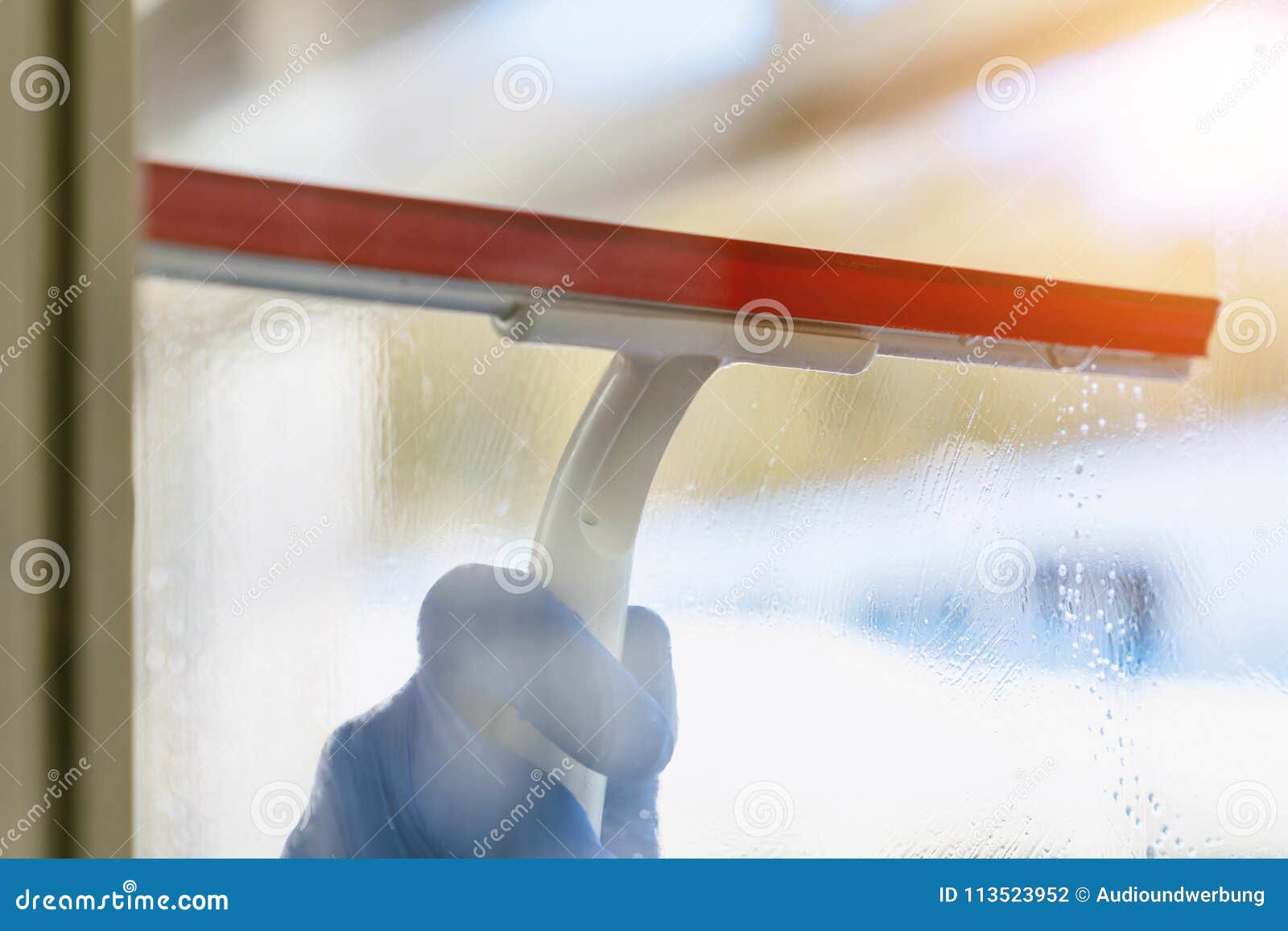 Young Man is Using a Rag and Squeegee while Cleaning Windows. Stock ...