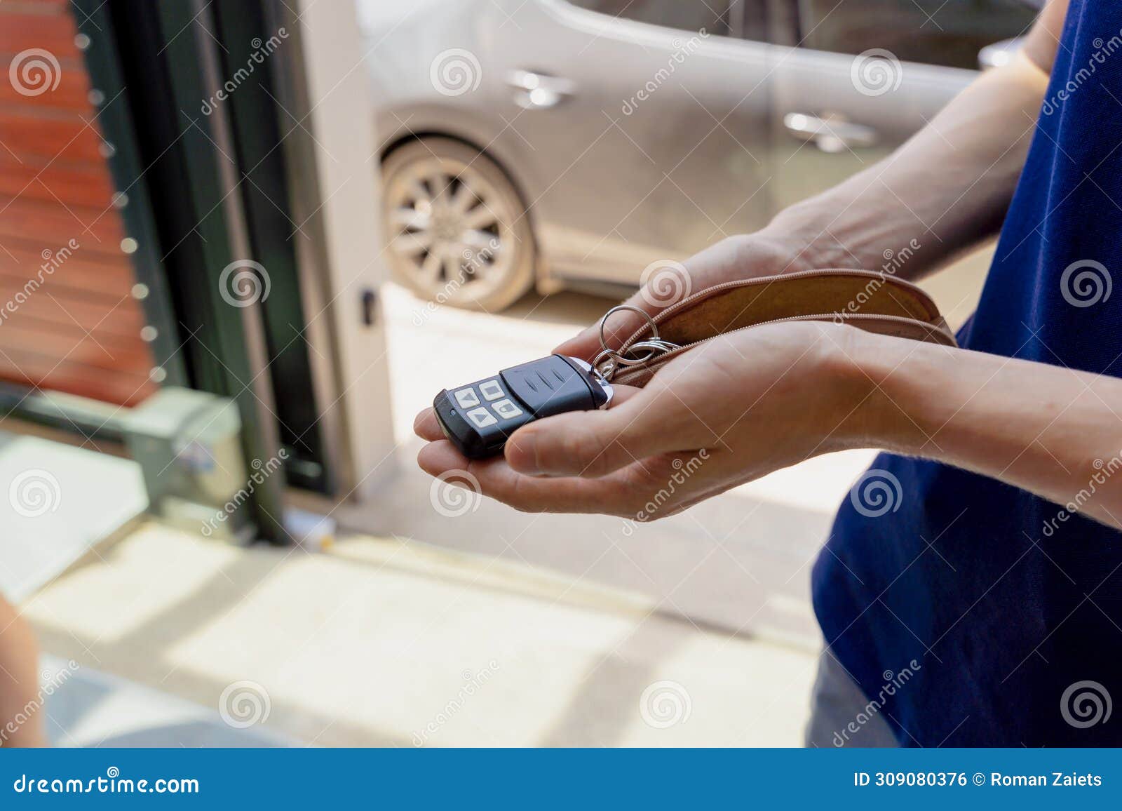 Young Man Using Remote Control To Open Automatic Sliding Front Gate at ...