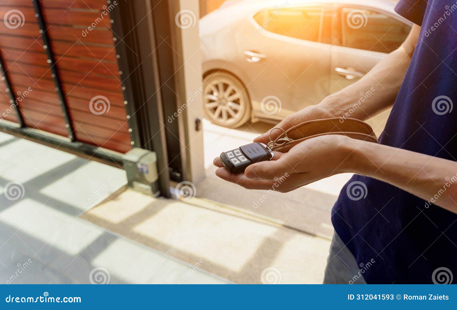Young Man Using Remote Control To Open Automatic Sliding Front Gate at ...
