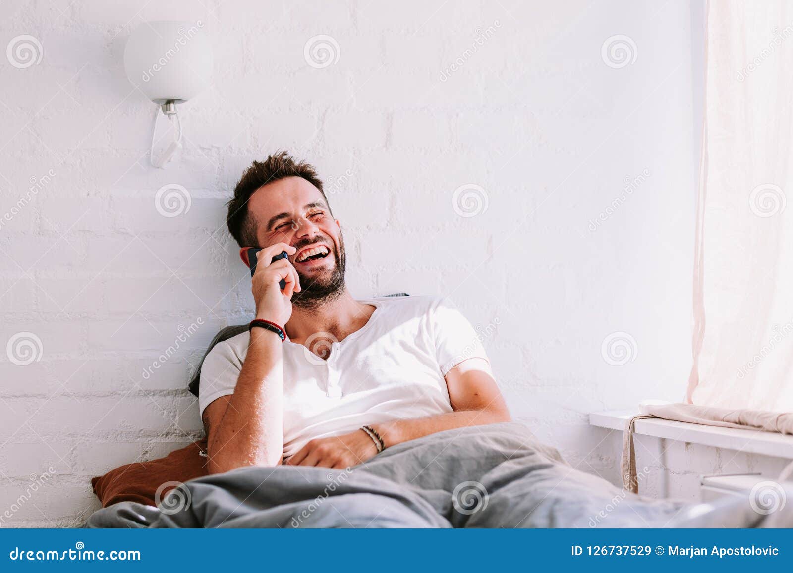 Young Man Using Smartphone in the Bed Stock Image - Image of lifestyle ...