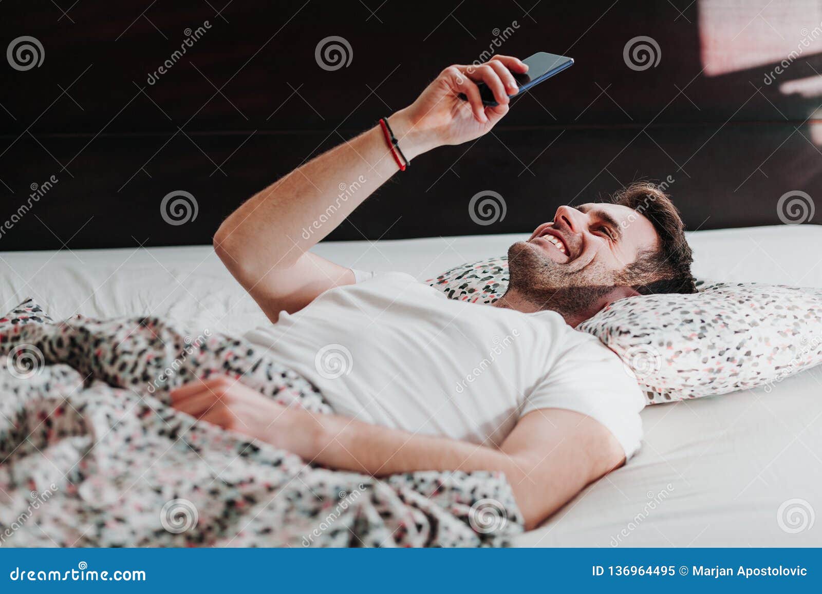 Young Man Using Smartphone in Bed Stock Image - Image of gadget, people ...