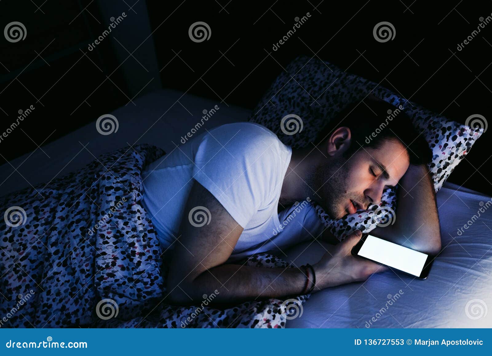 Young Man Using Smartphone in Bed at Night Stock Image - Image of face ...