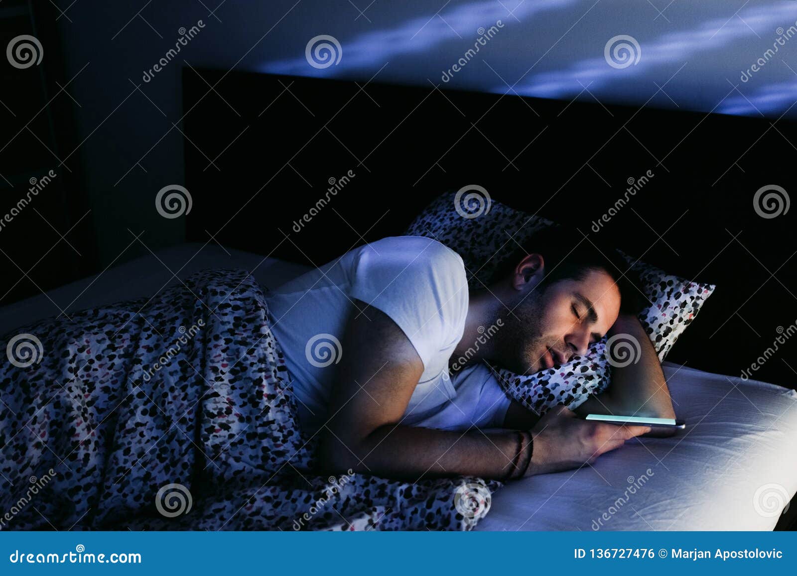 Young Man Using Smartphone in Bed at Night Stock Photo - Image of ...