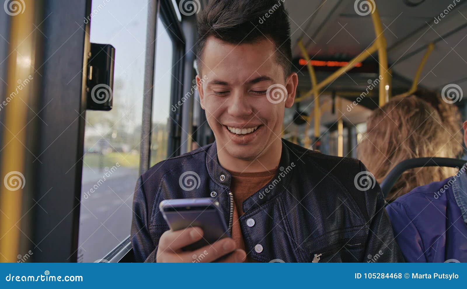 A Young Man Using a Smartphone on the Bus Stock Photo - Image of device ...