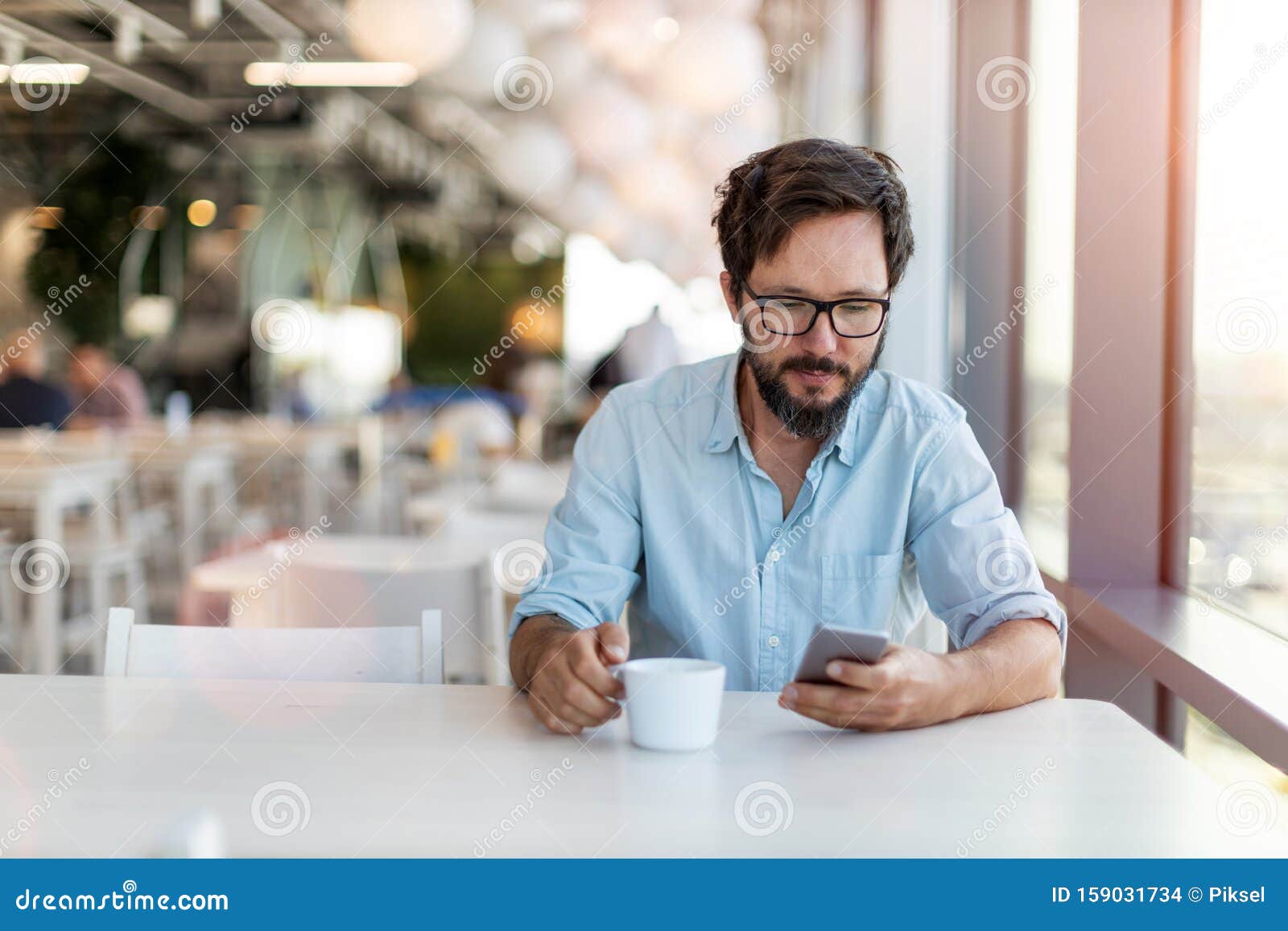 Young Man Using Smartphone in a Cafe Stock Photo - Image of gadget ...