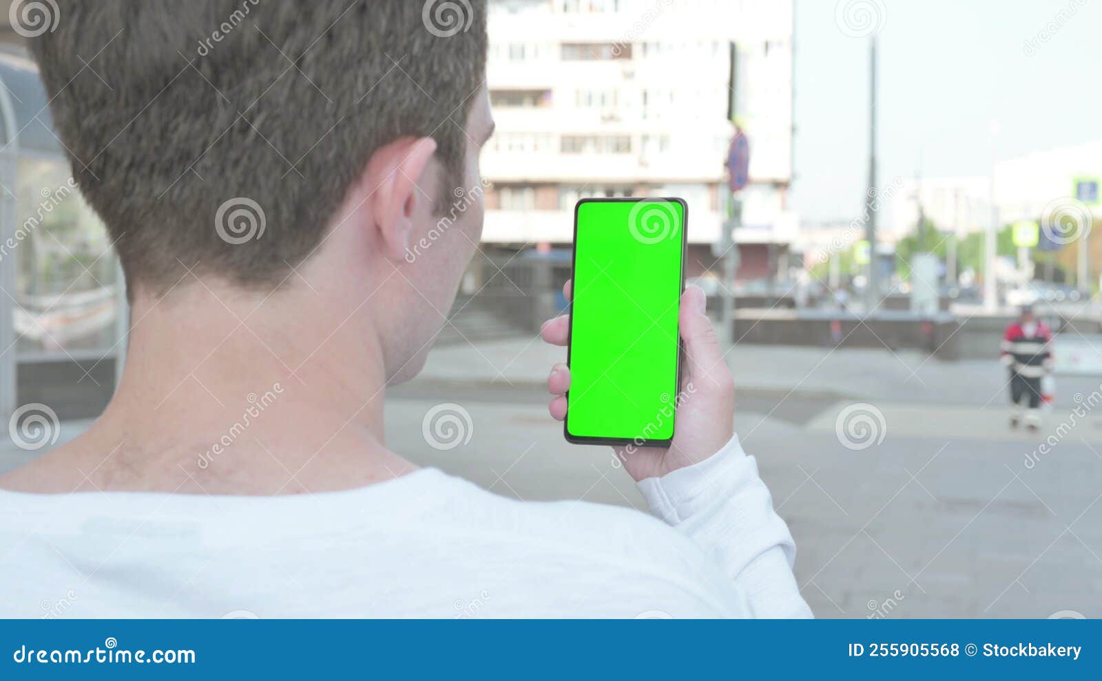 Young Man Using Smartphone with Green Screen Outdoor Stock Photo ...