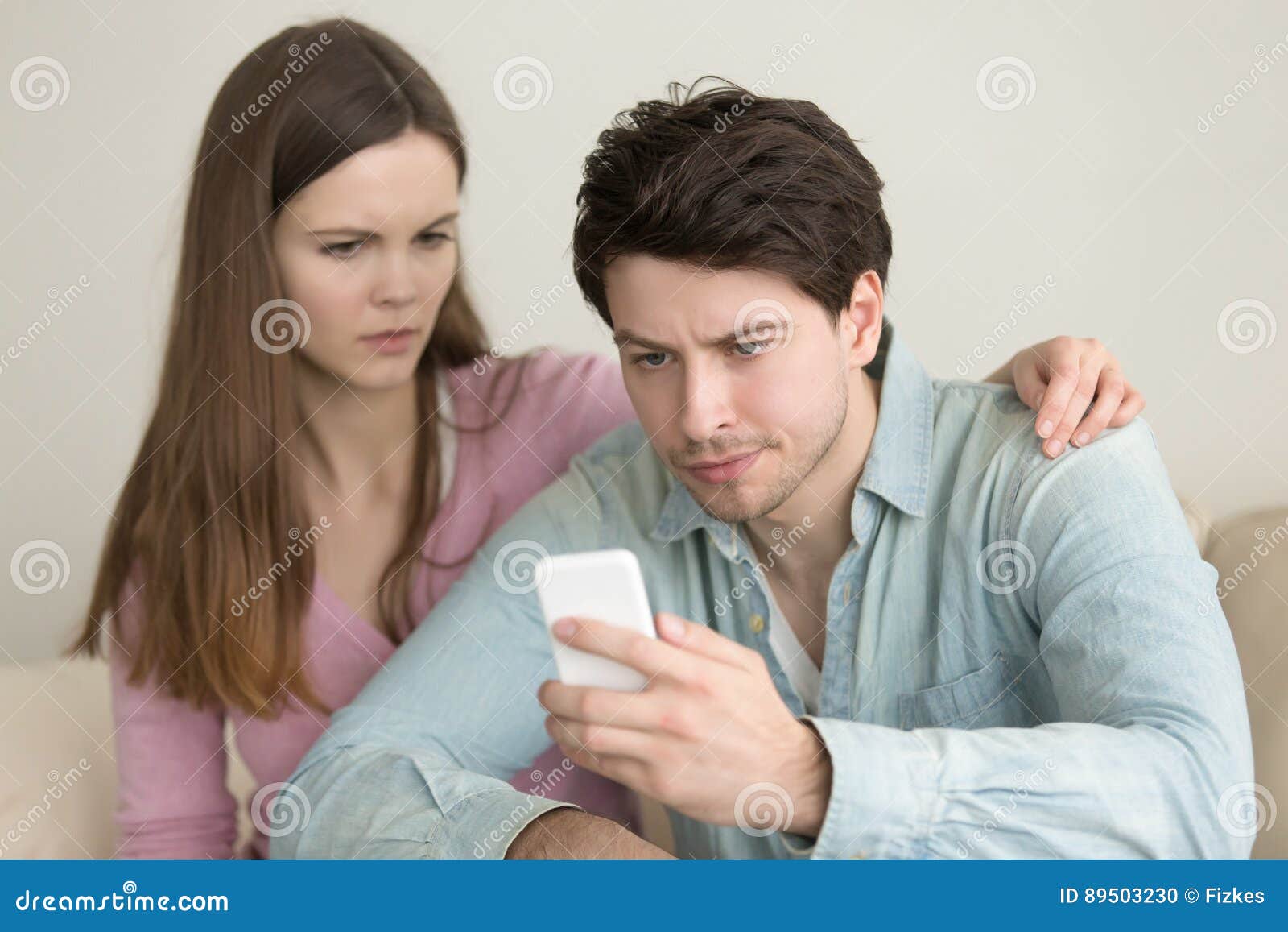 Young Man Using Smartphone, Having Problems, Girlfriend Anxious Stock ...