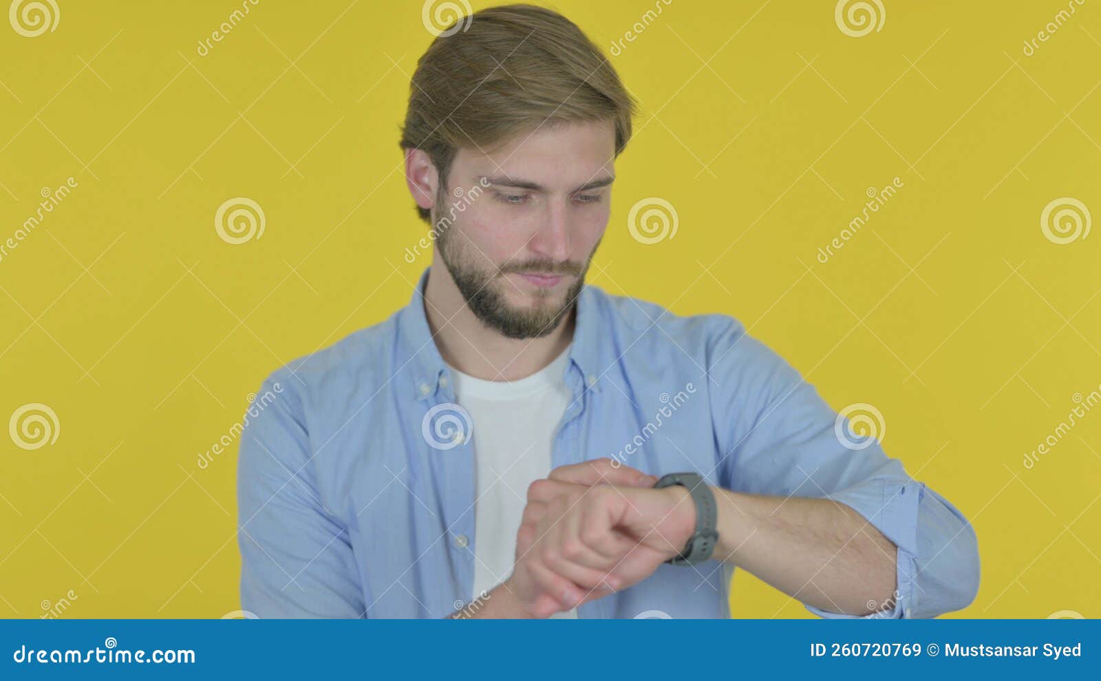 Young Man Using Smartwatch on Yellow Background Stock Image - Image of ...