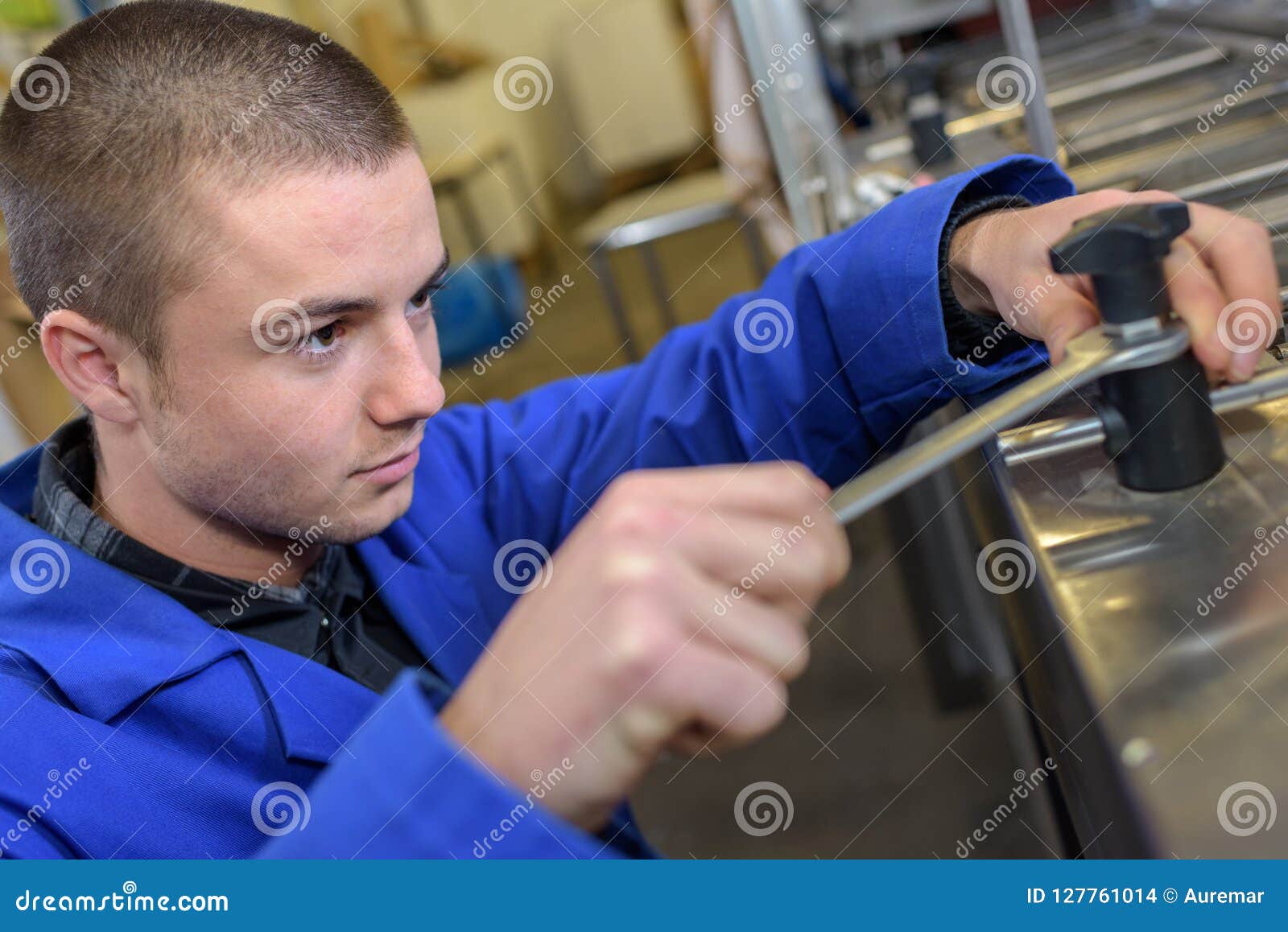 Young man using spanner stock photo. Image of controlling - 127761014