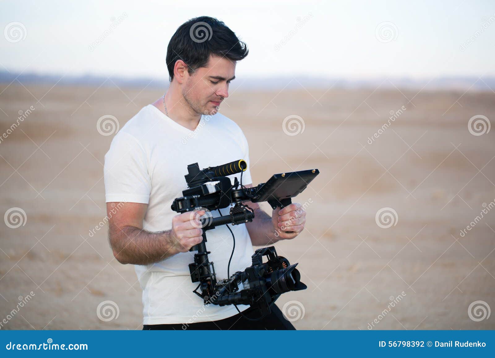 Young Man Using Steadycam for Shooting on Beach Stock Photo - Image of ...