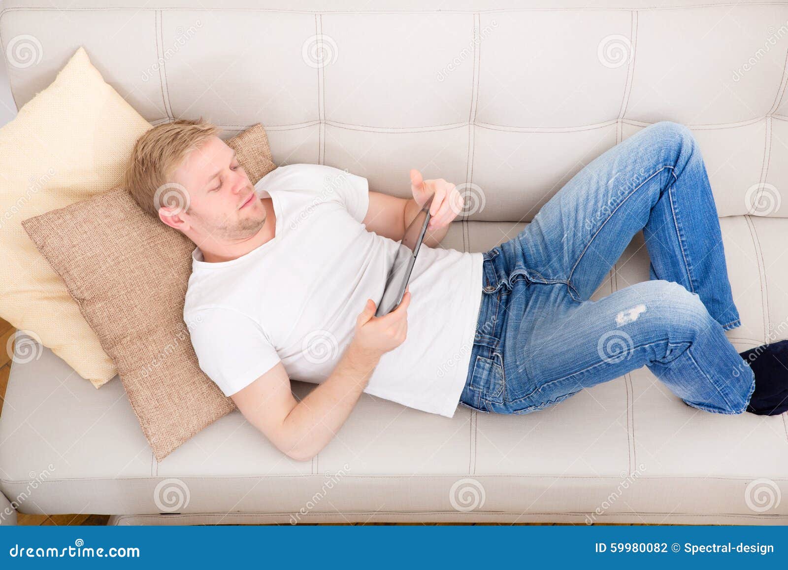 Young Man Using a Tablet at Home Stock Photo - Image of handsome ...
