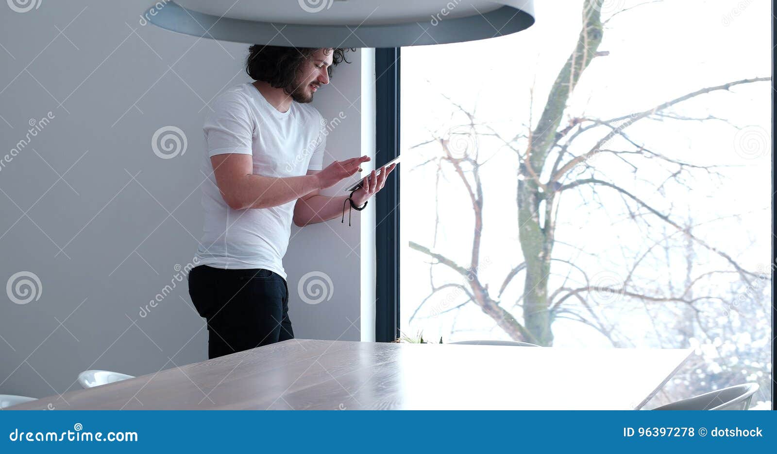 Young Man Using a Tablet at Home Stock Photo - Image of sitting ...