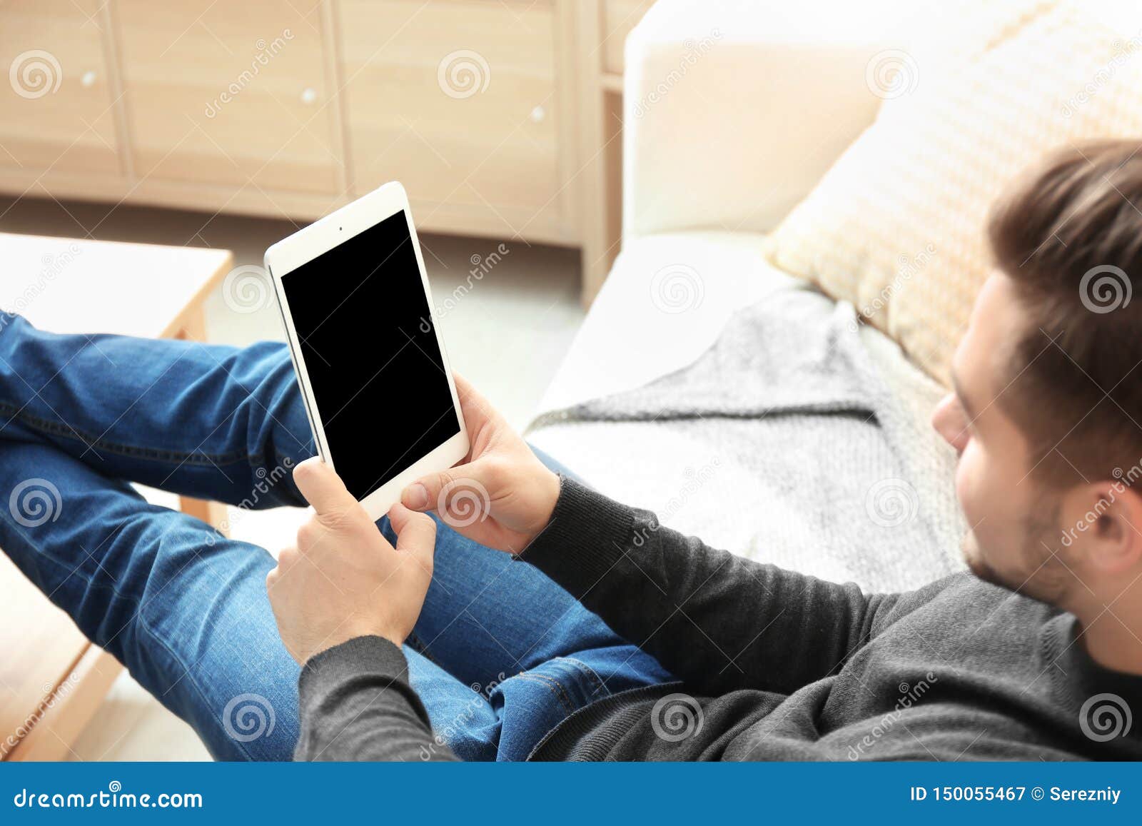 Young Man Using Tablet at Home Stock Image - Image of messaging ... Young Man Using Tablet at Home Stock Image - Image of messaging ...