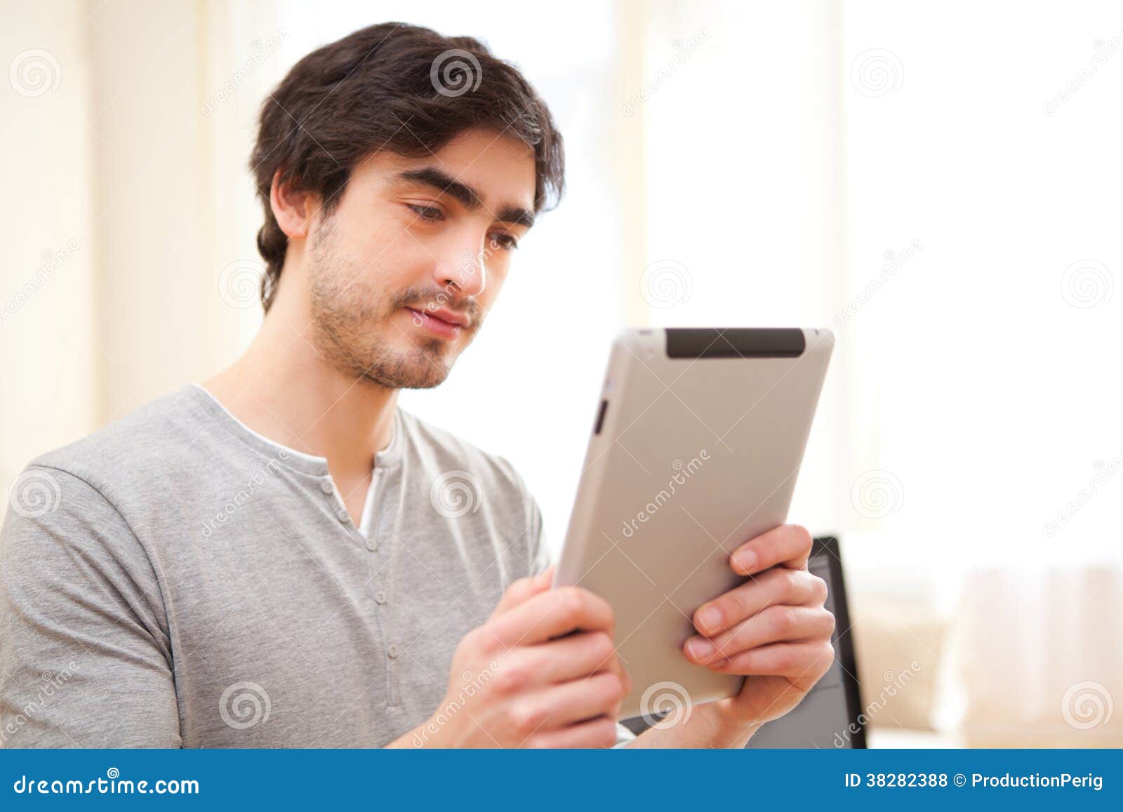 Young Man Using a Tablet at the Office Stock Photo - Image of desk ...