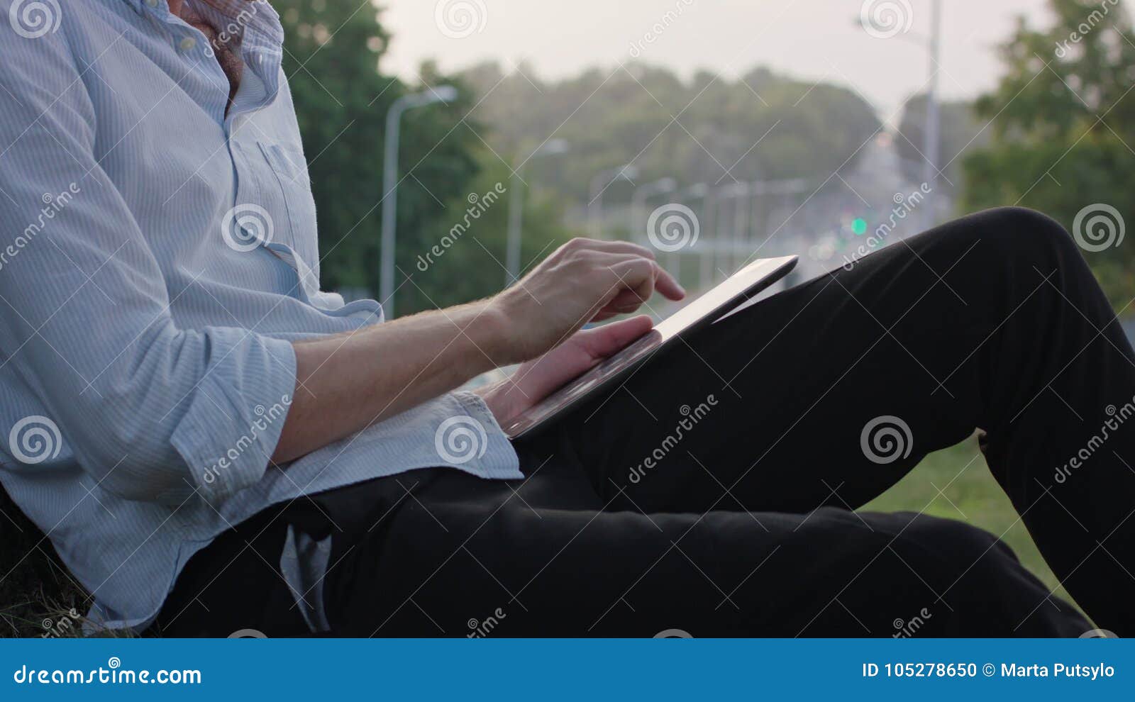 A Young Man Using a Tablet Outdoors Stock Photo - Image of outdoors ...