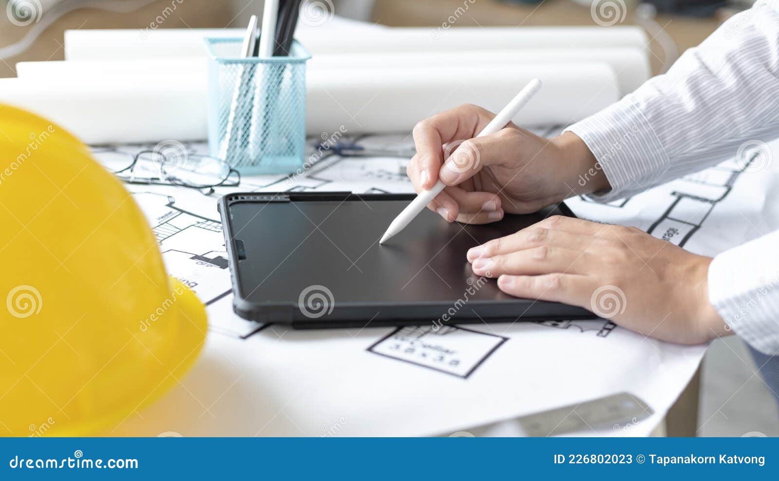 Young Man Using Tablet Plotting a System of Building Structures in ...