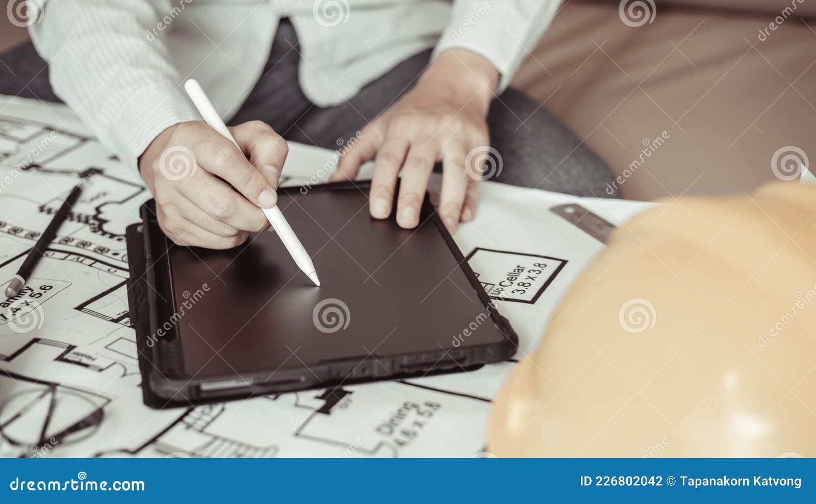 Young Man Using Tablet Plotting a System of Building Structures in ...