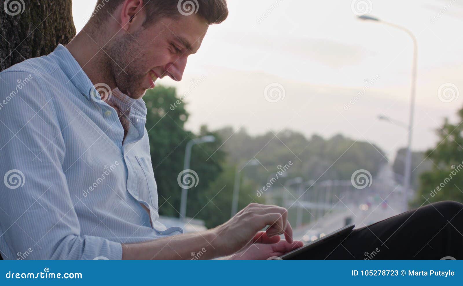 A Young Man Using a Tablet Outdoors Stock Image - Image of cityscape ...