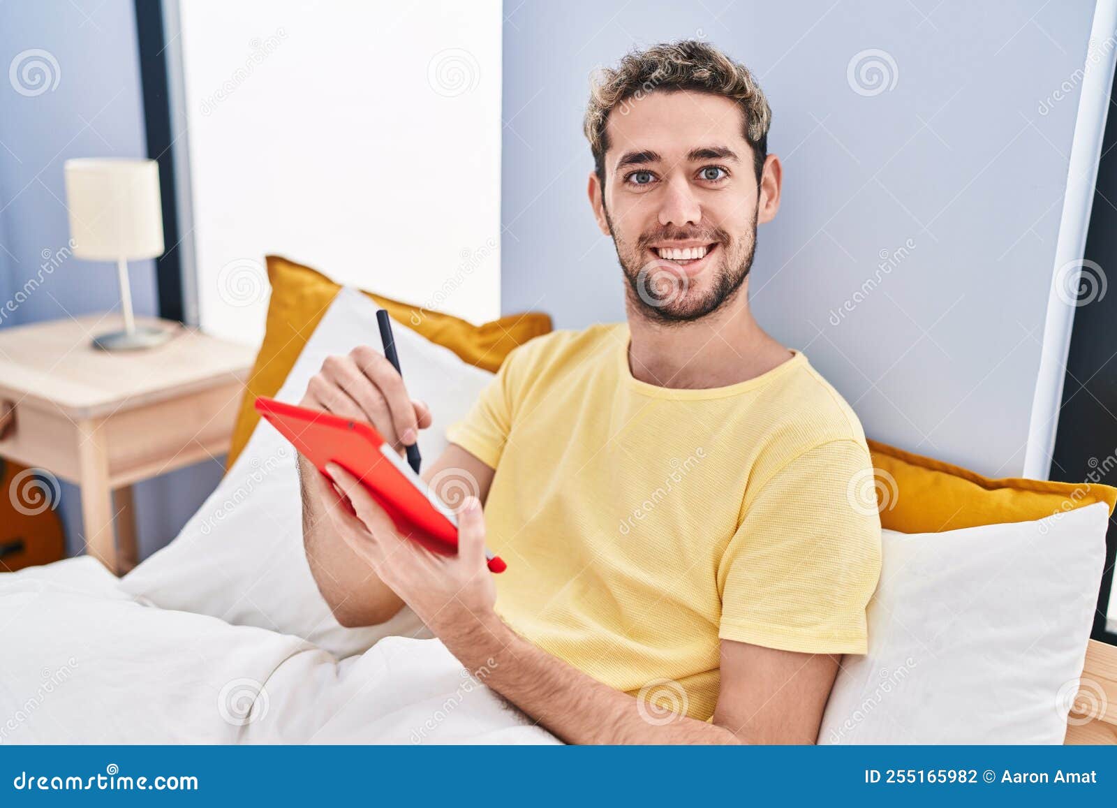 Young Man Using Touchpad Sitting on Bed at Bedroom Stock Photo - Image ... Young Man Using Touchpad Sitting on Bed at Bedroom Stock Photo - Image ...