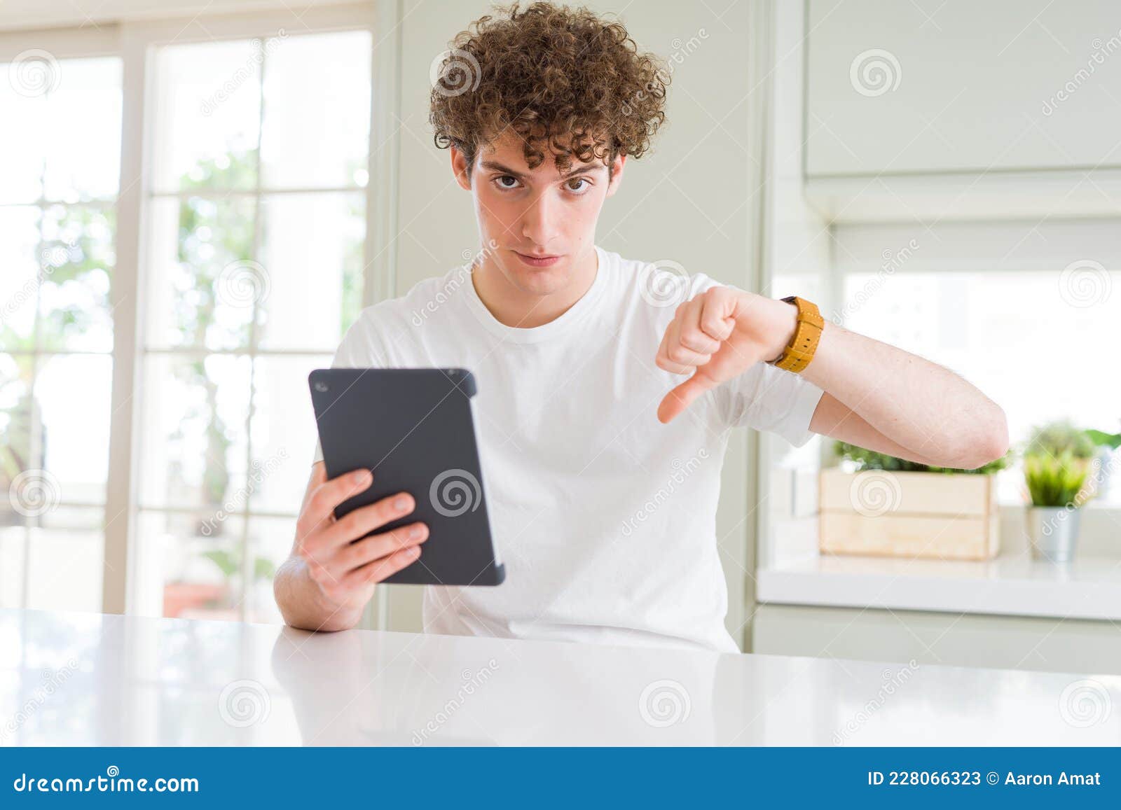 Young Man Using Touchpad Tablet with Angry Face, Negative Sign Showing ...
