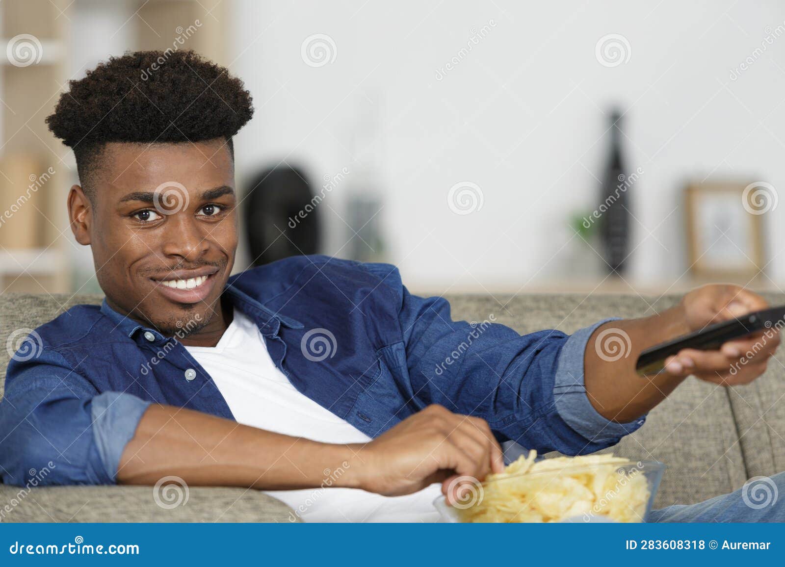 Young Man Using Tv Remote Control Stock Photo - Image of male, handsome ...