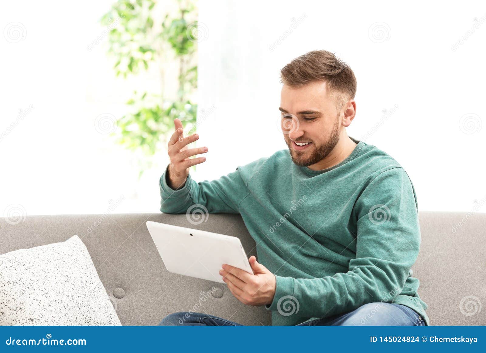 Young Man Using Video Chat on Tablet in Room Stock Photo - Image of ...
