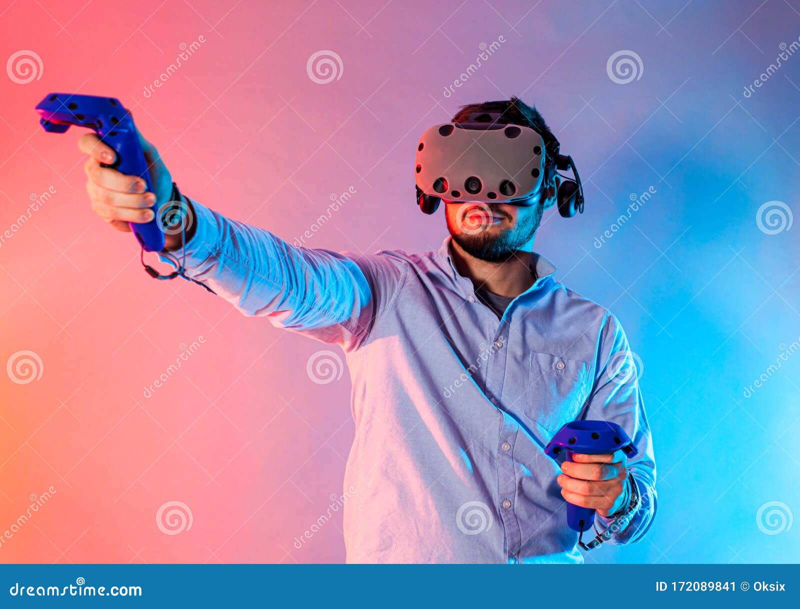 Young Man Using the Virtual Reality Glasses and Two Gamepad Stock Image ...