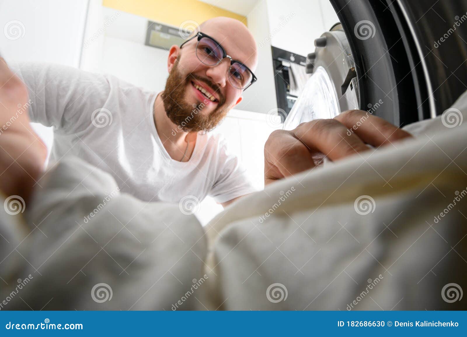 Young Man Using Washing Machine at Home. Laundry Day Stock Photo ...