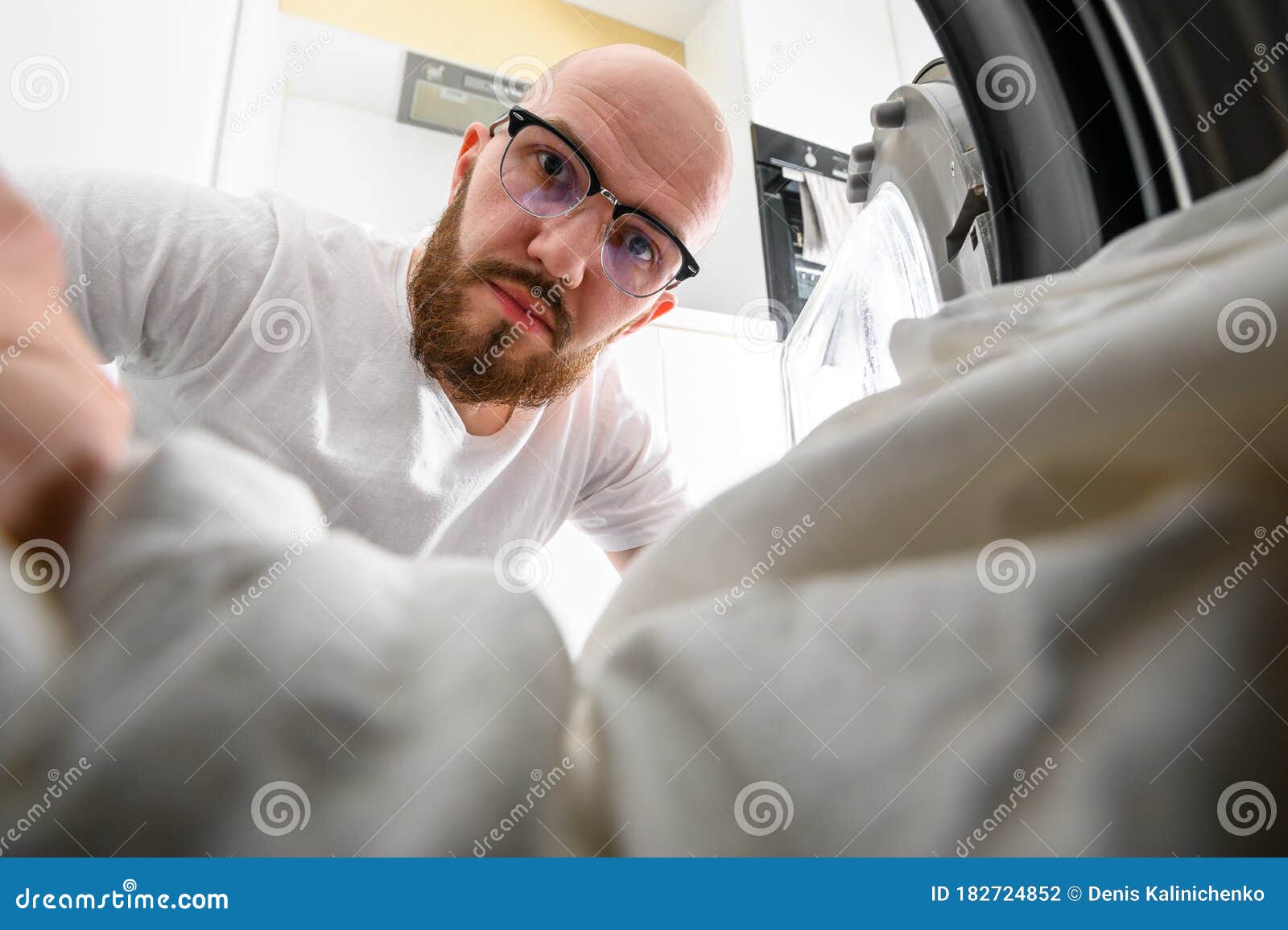 Young Man Using Washing Machine at Home. Laundry Day Stock Photo ...