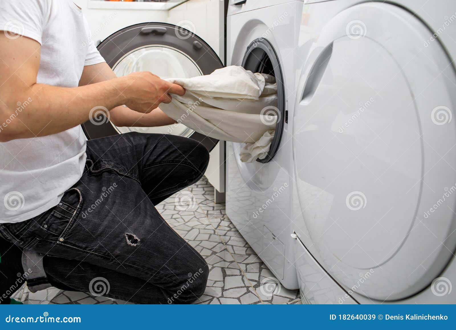 Young Man Using Washing Machine at Home. Laundry Day Stock Image ...