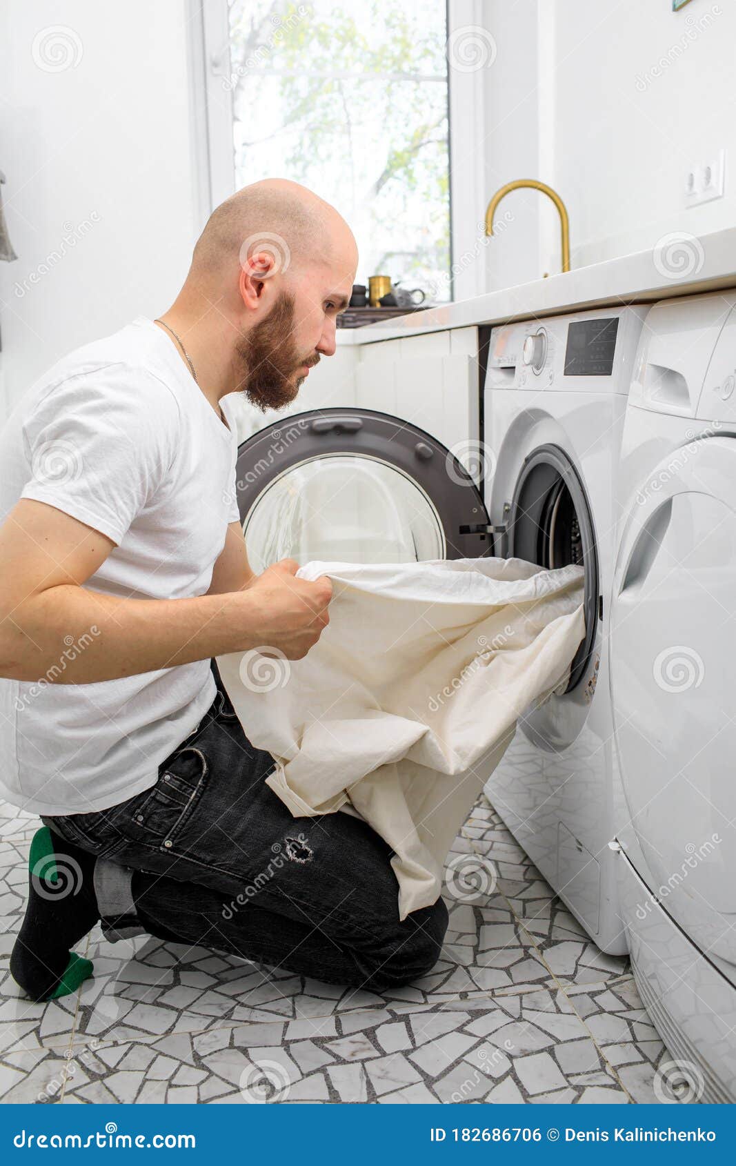 Young Man Using Washing Machine at Home. Laundry Day Stock Photo ...