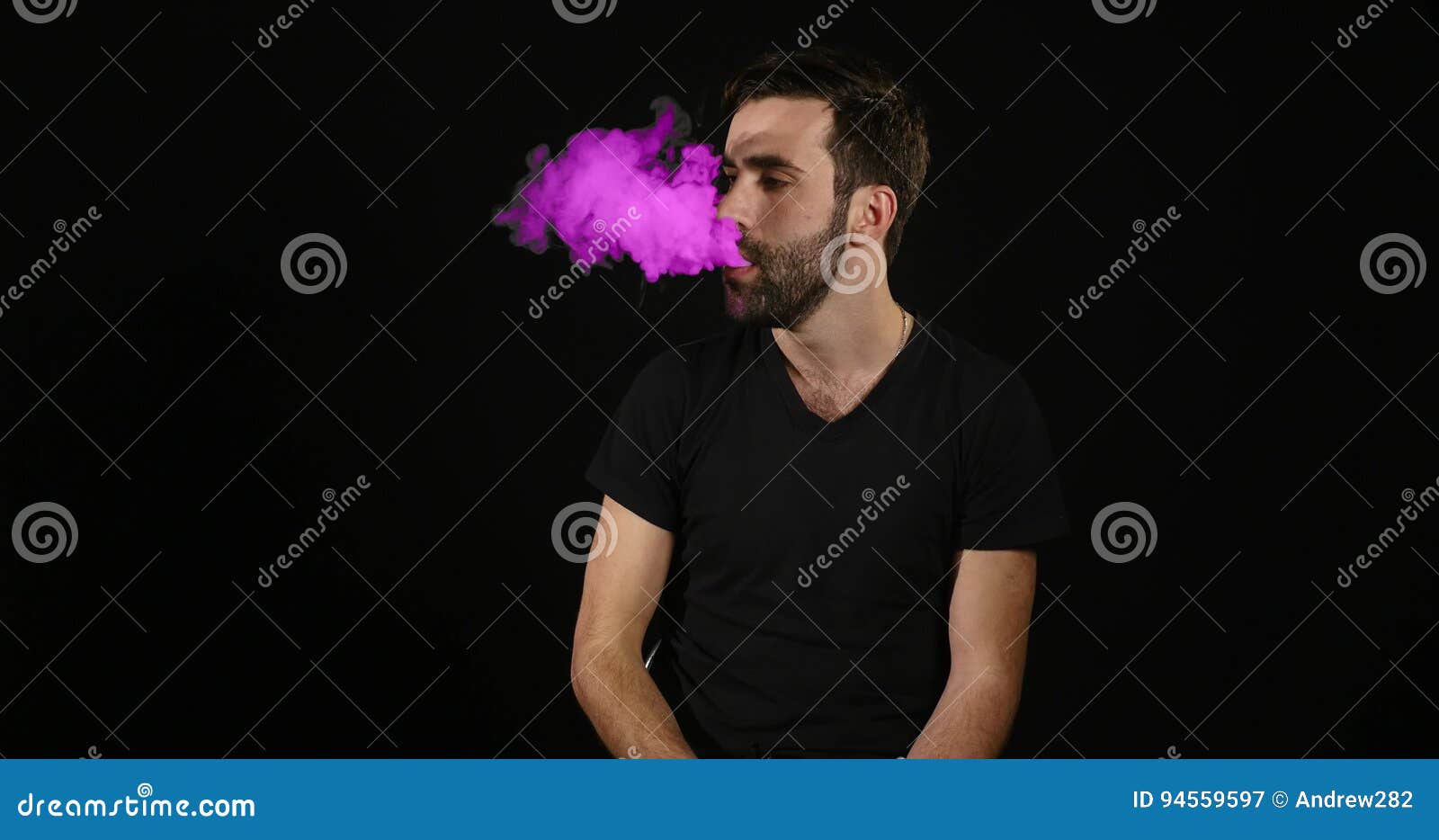 Young Man Vaping with an Electronic Cigarette and Make Some Pink Smoke ...