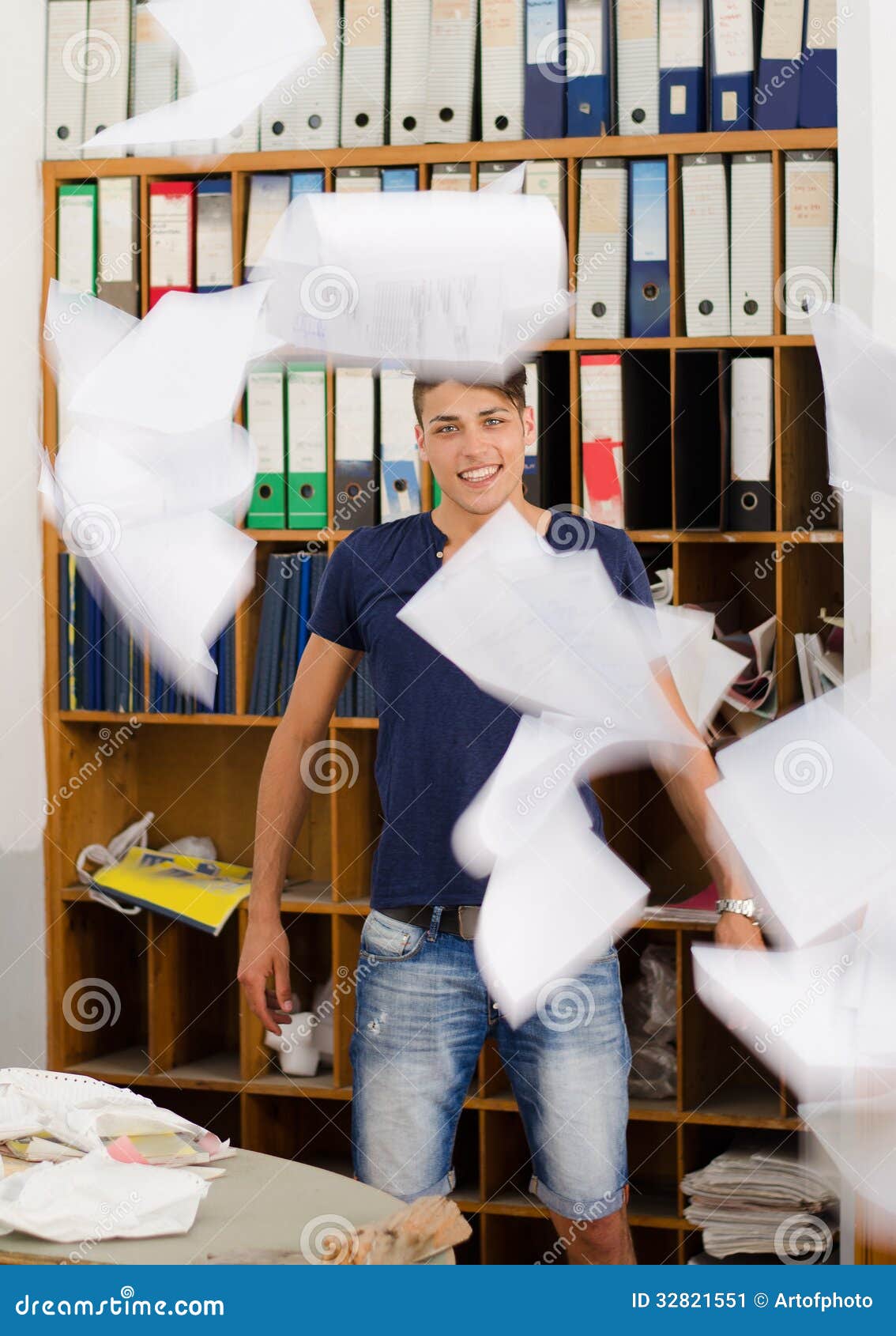 Young Man in Very Messy Office with Documents Flying Stock Image ...