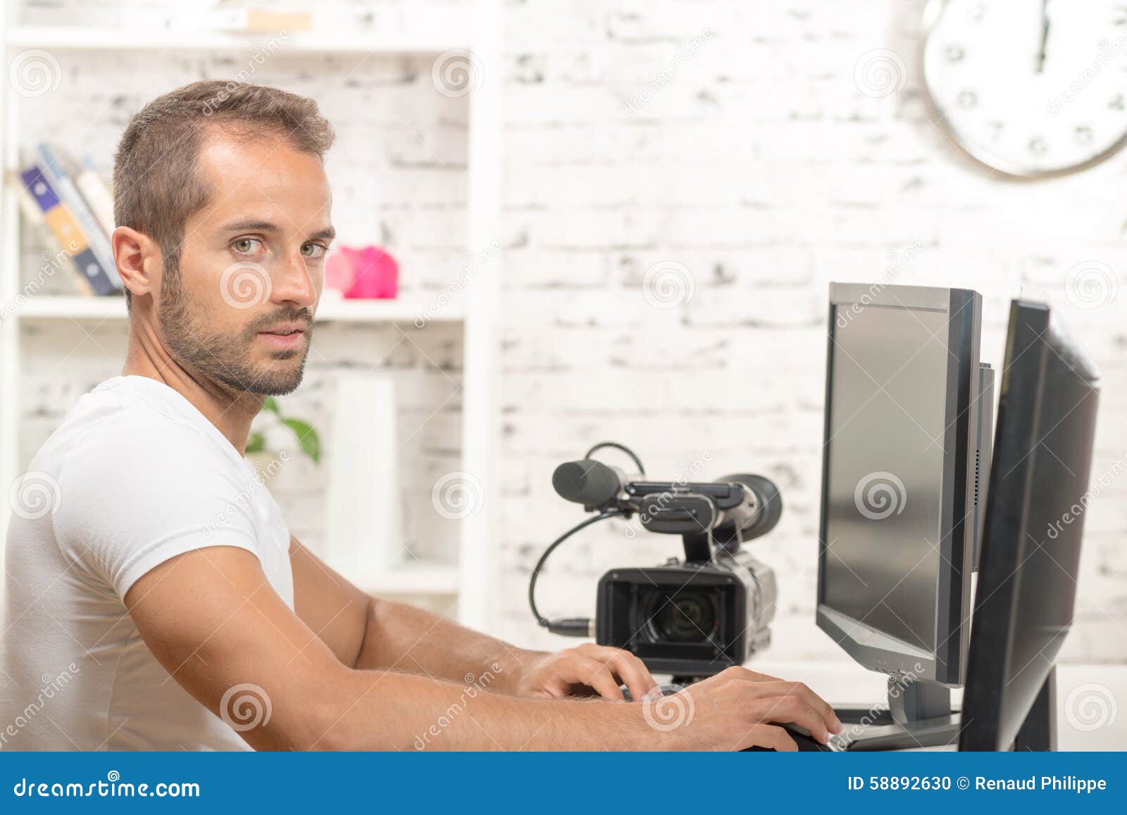 A young man video editor stock photo. Image of working - 58892630