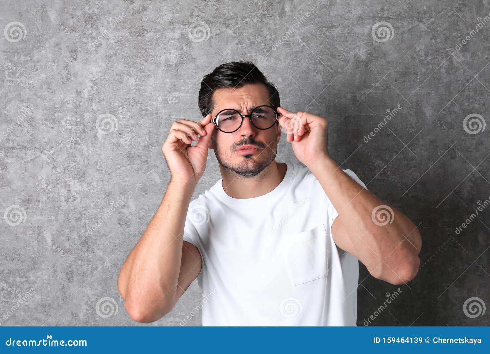 Young Man with Vision Problem Wearing Glasses on Background Stock Image ...