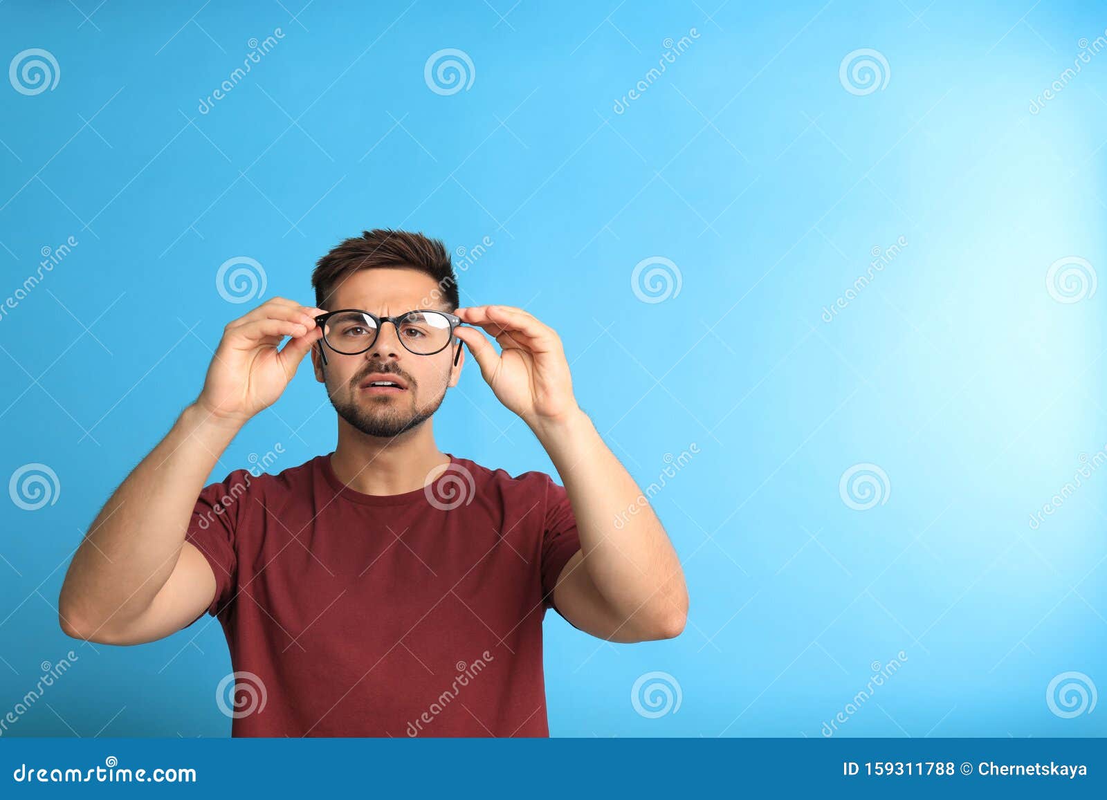 Young Man with Vision Problems Wearing Glasses on Blue Background Stock ...
