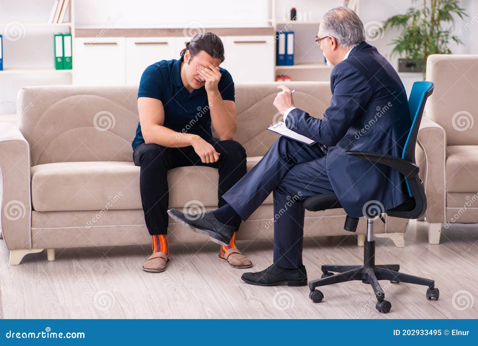 Young Man Visiting Old Male Psychologist Stock Image - Image of ...