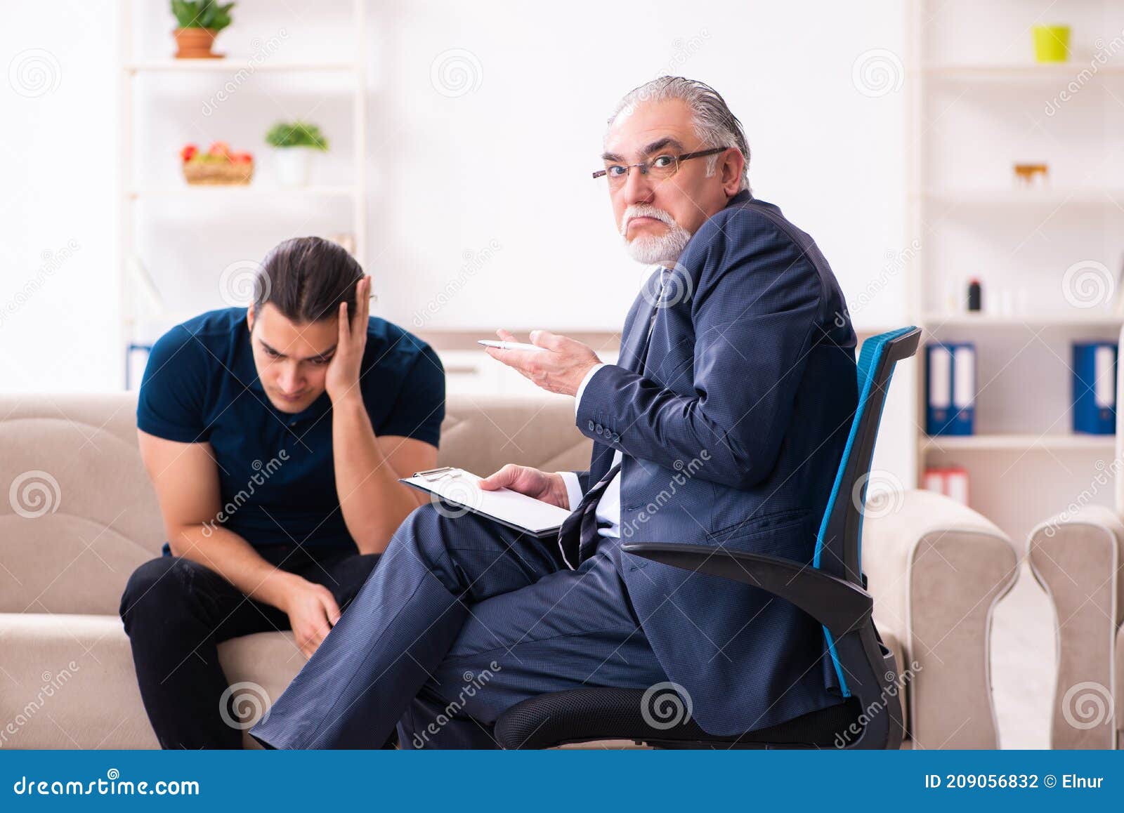 Young Man Visiting Old Male Psychologist Stock Photo - Image of helping ...